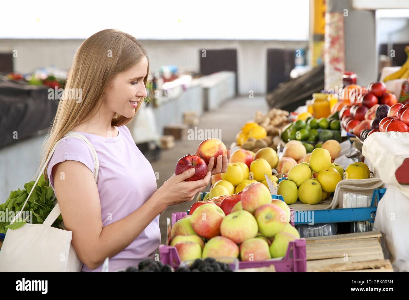 Woman choosing fruits at market Stock Photo - Alamy