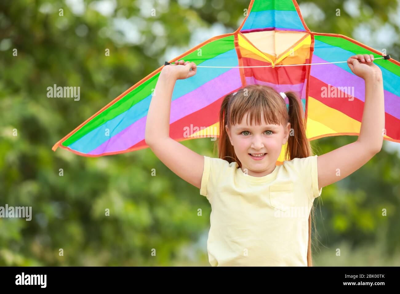 Little girl flying kite outdoors Stock Photo - Alamy