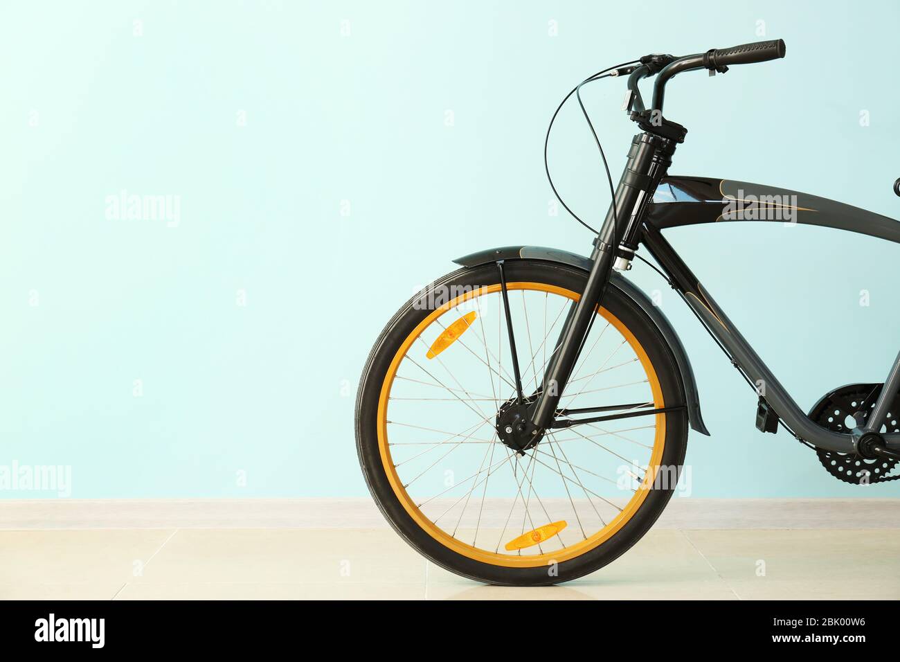 Modern bicycle near light color wall Stock Photo - Alamy