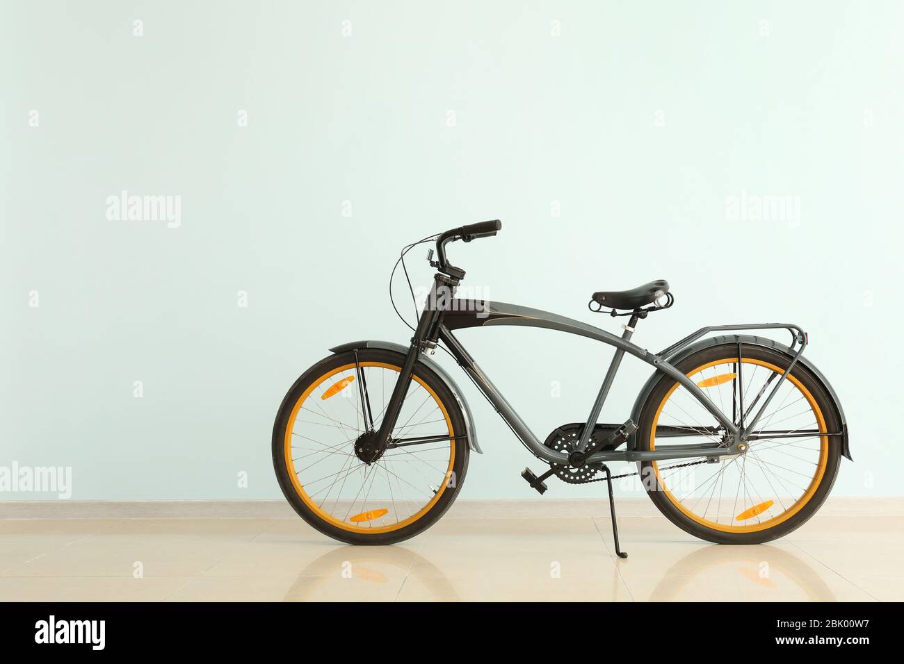 Modern bicycle near light color wall Stock Photo - Alamy