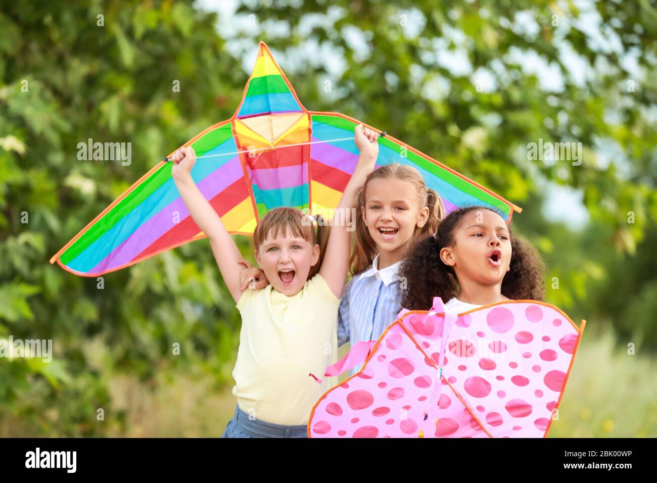 Little girls flying kites outdoors Stock Photo - Alamy