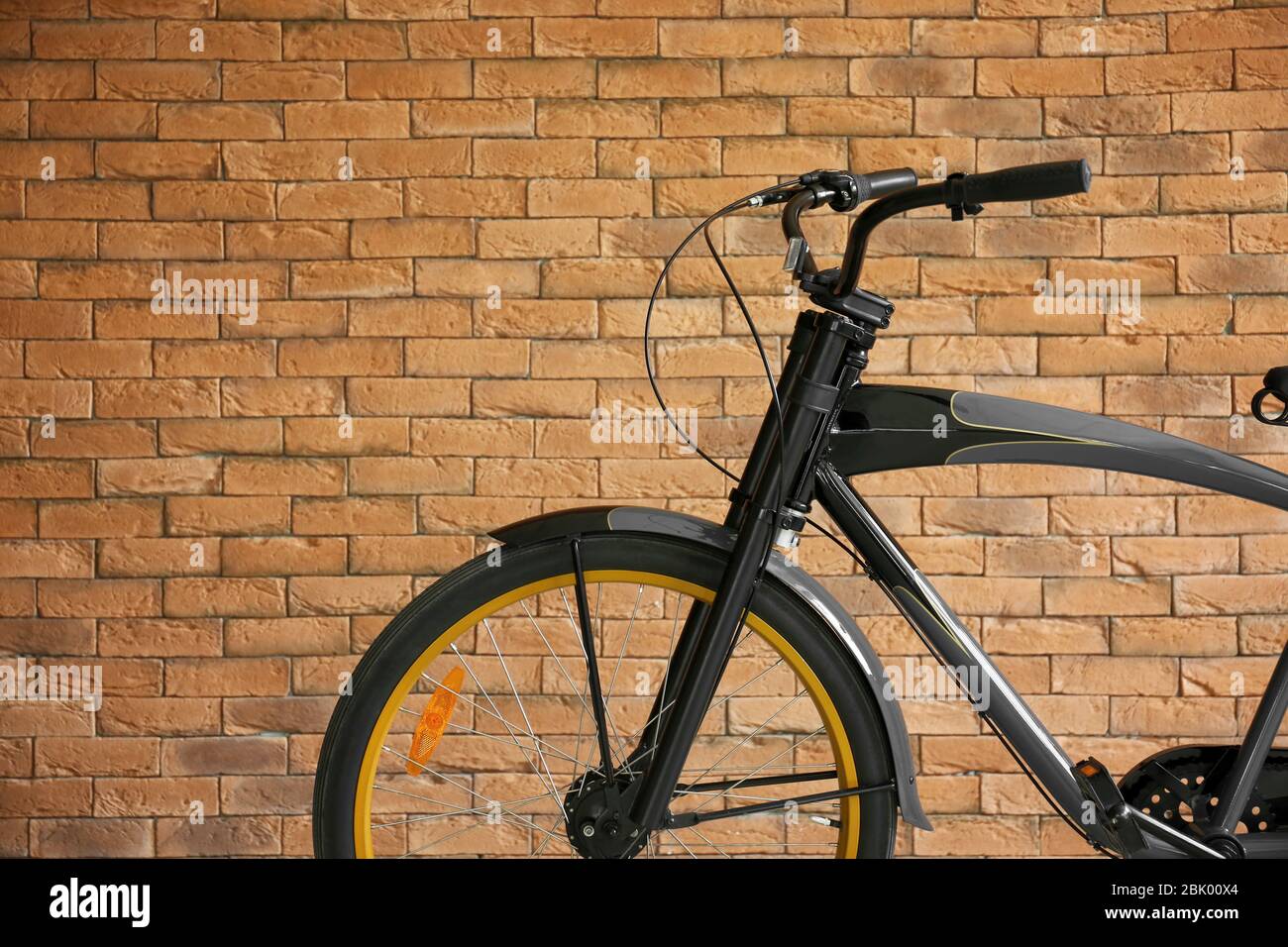 Modern bicycle near brick wall Stock Photo - Alamy