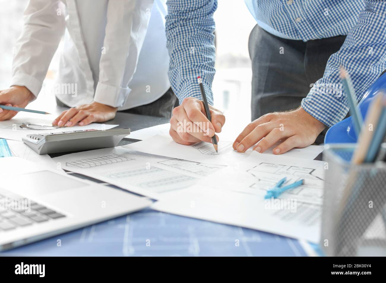 Architects working on project of building in office Stock Photo - Alamy