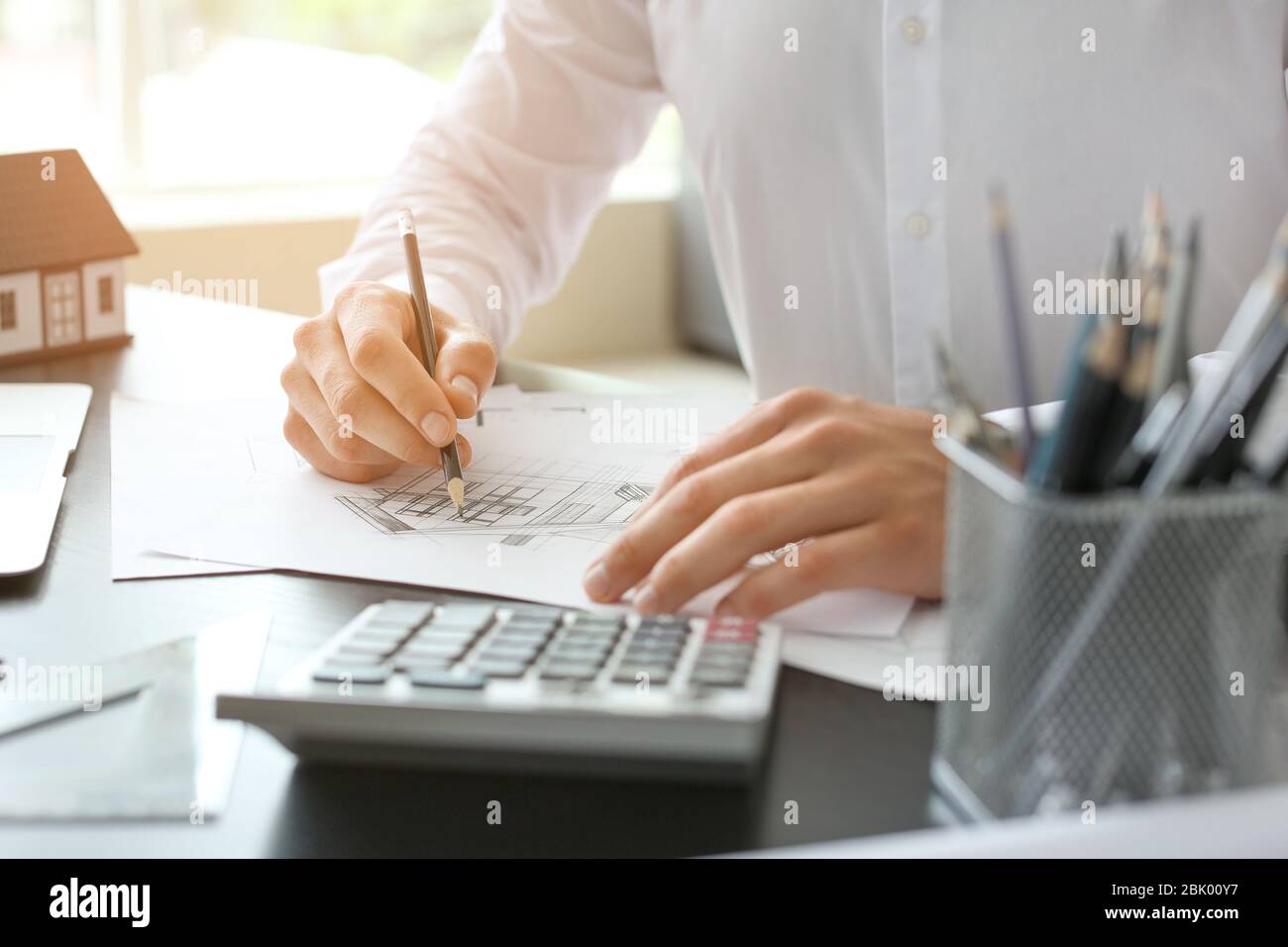 Architect working on project of building in office Stock Photo - Alamy
