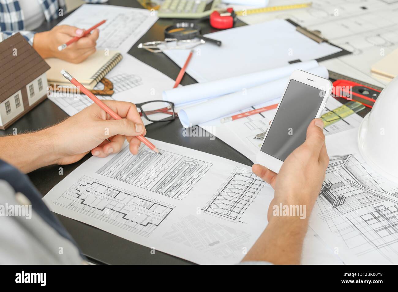 Architects working on project of building in office Stock Photo - Alamy