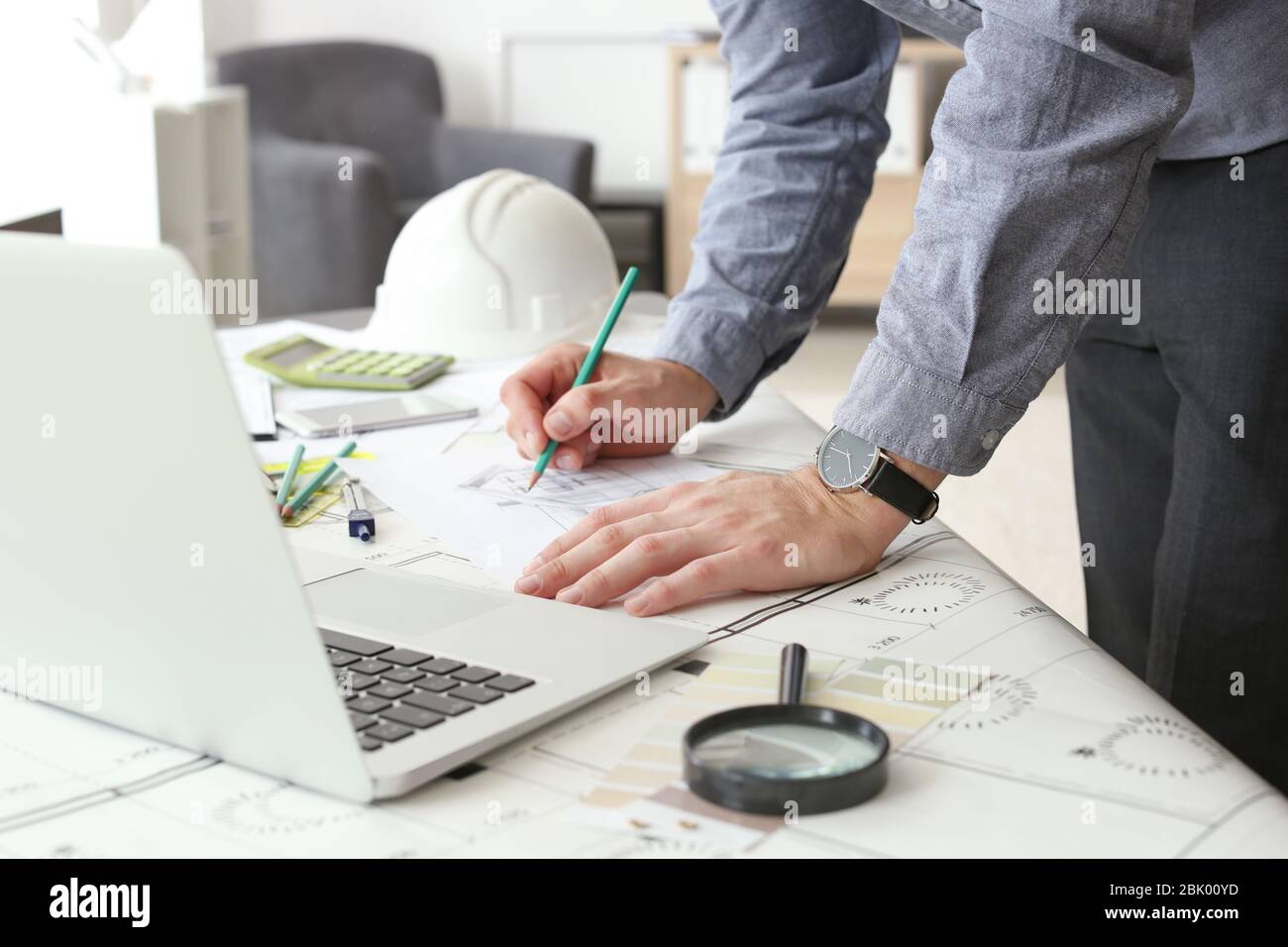 Architect working on project of building in office Stock Photo - Alamy