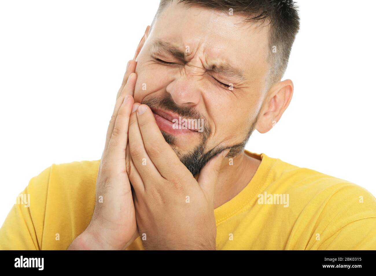 Man suffering from toothache against white background Stock Photo - Alamy