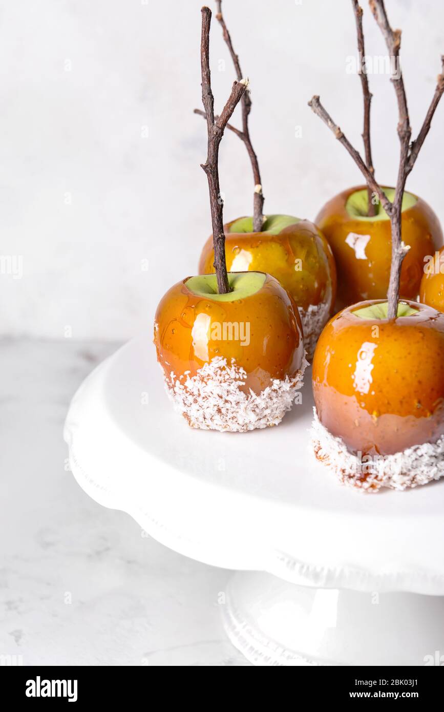 Dessert stand with tasty candy apples on table, closeup Stock Photo - Alamy