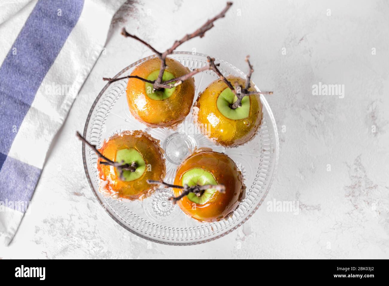 Dessert stand with tasty candy apples on table Stock Photo - Alamy
