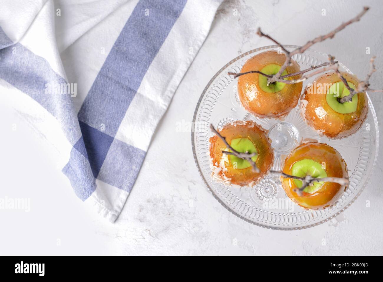 Dessert stand with tasty candy apples on table Stock Photo - Alamy