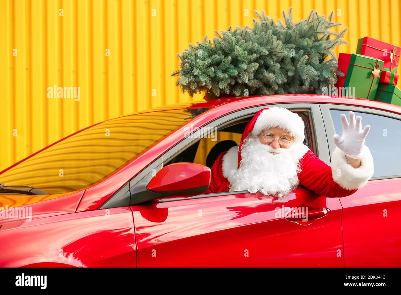 Santa Claus with gifts driving modern car Stock Photo - Alamy