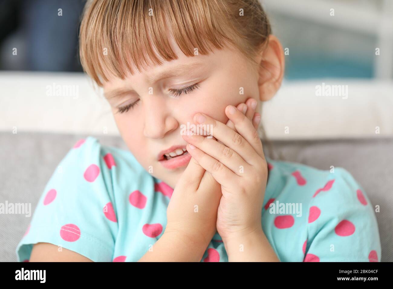 Little girl suffering from toothache at home Stock Photo - Alamy