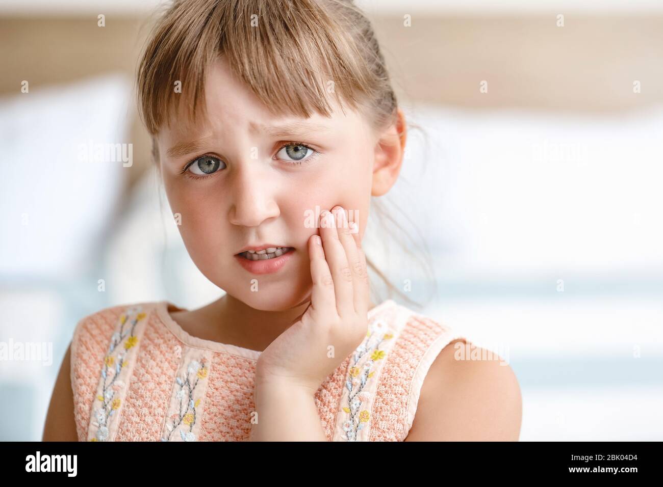 Little girl suffering from toothache at home Stock Photo - Alamy