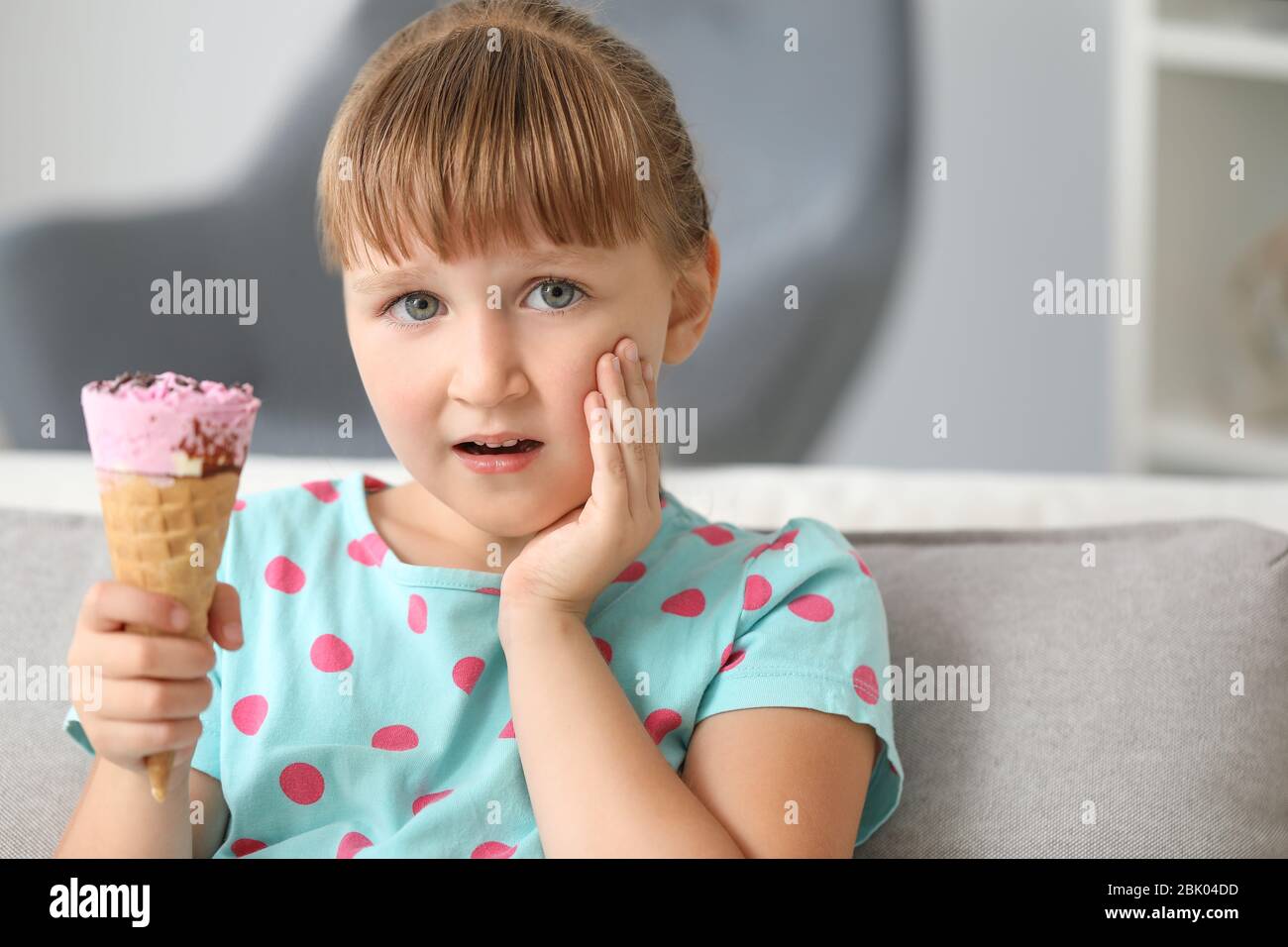 Little girl with sensitive teeth and cold ice-cream at home Stock Photo ...