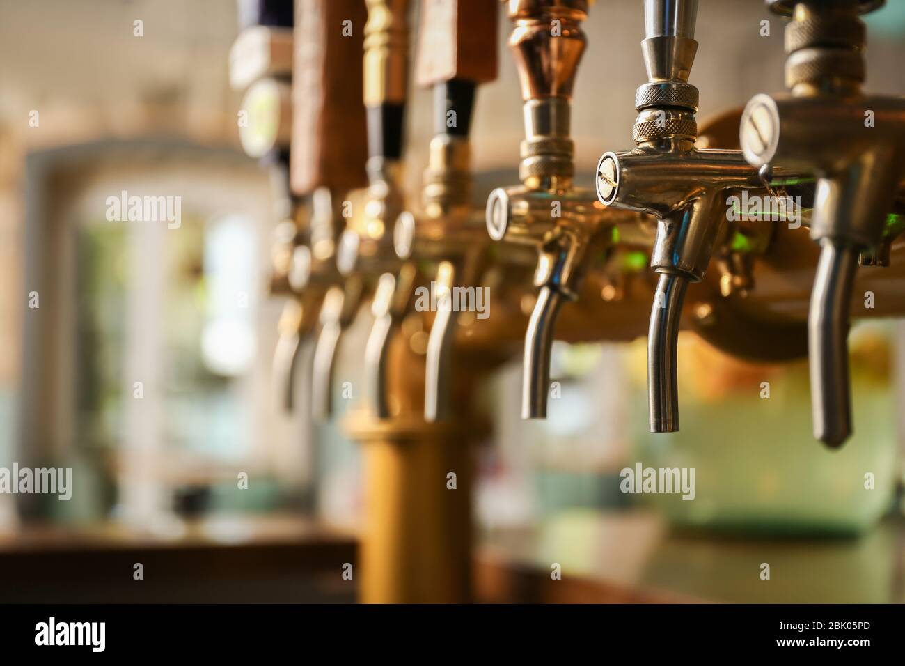 Draft beer taps in modern bar Stock Photo - Alamy