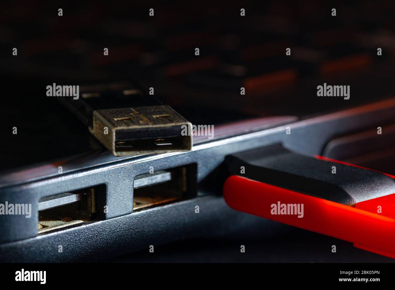 Flash drive in USB port of computer notebook in darkness. Concept of ...