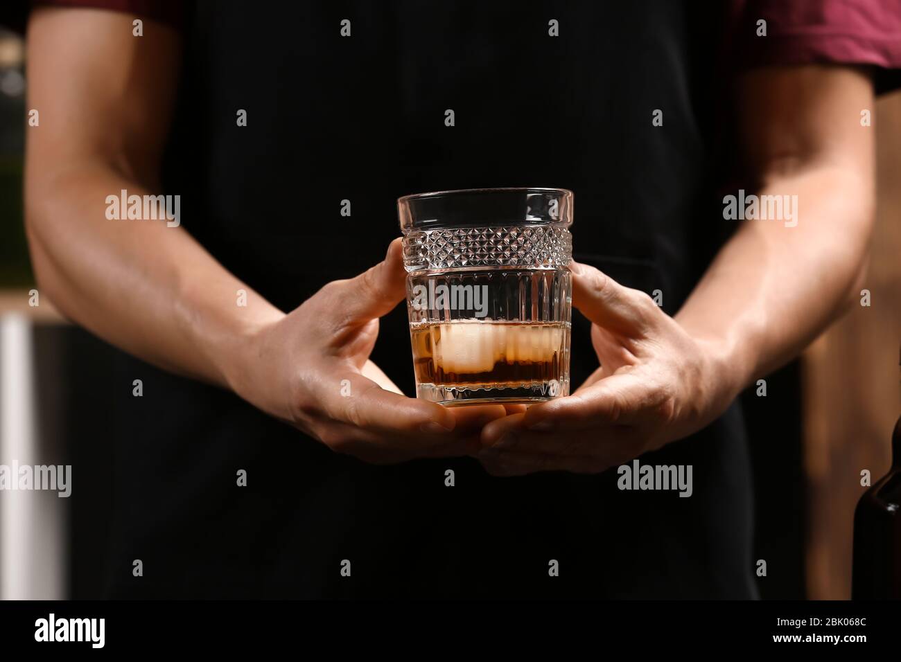 Barman with glass of whiskey in pub, closeup Stock Photo - Alamy