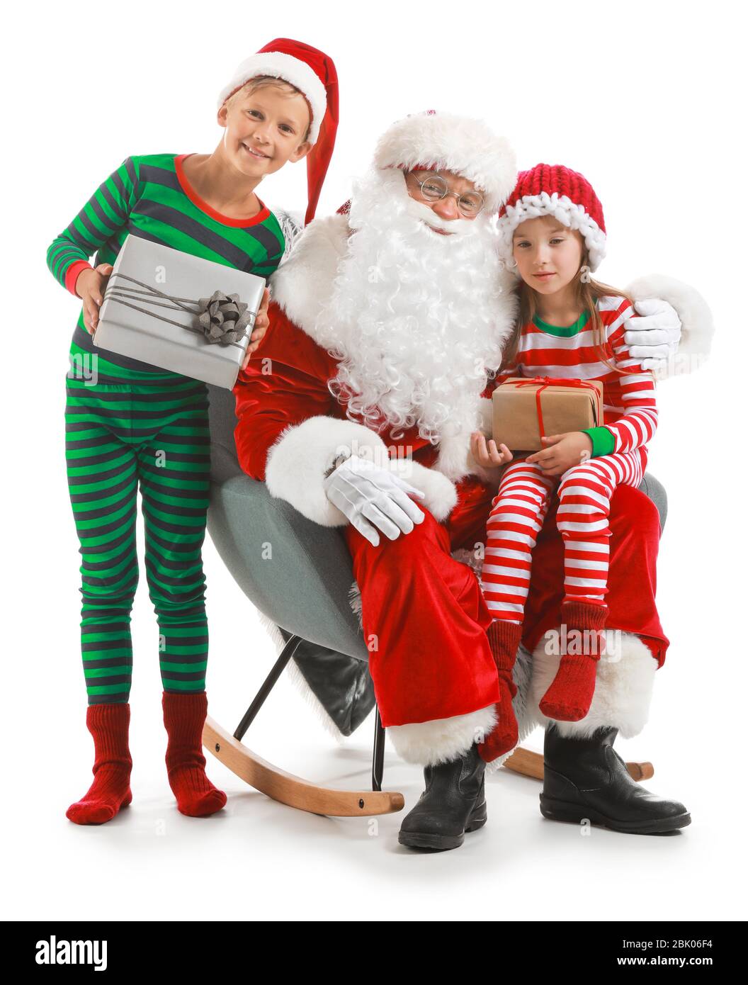 Santa Claus and little elf kids against white background Stock Photo ...