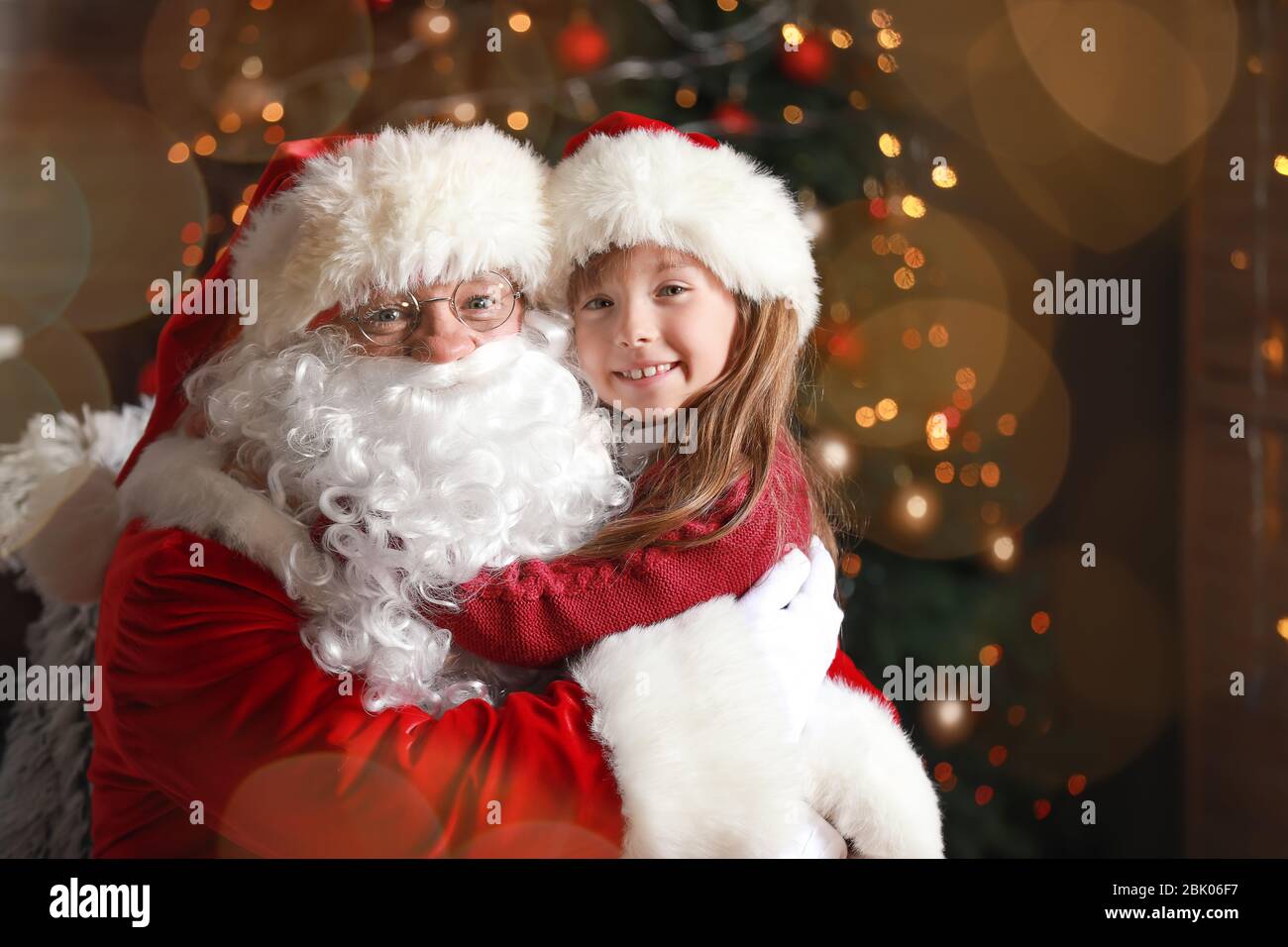 Santa claus hugging little girl hi-res stock photography and images - Alamy
