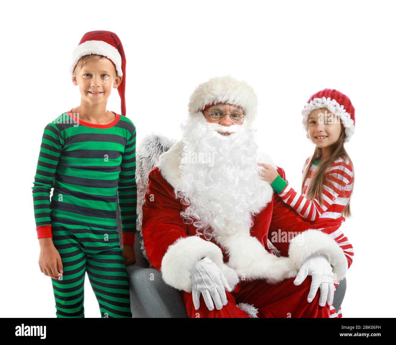 Santa Claus and little elf kids against white background Stock Photo ...