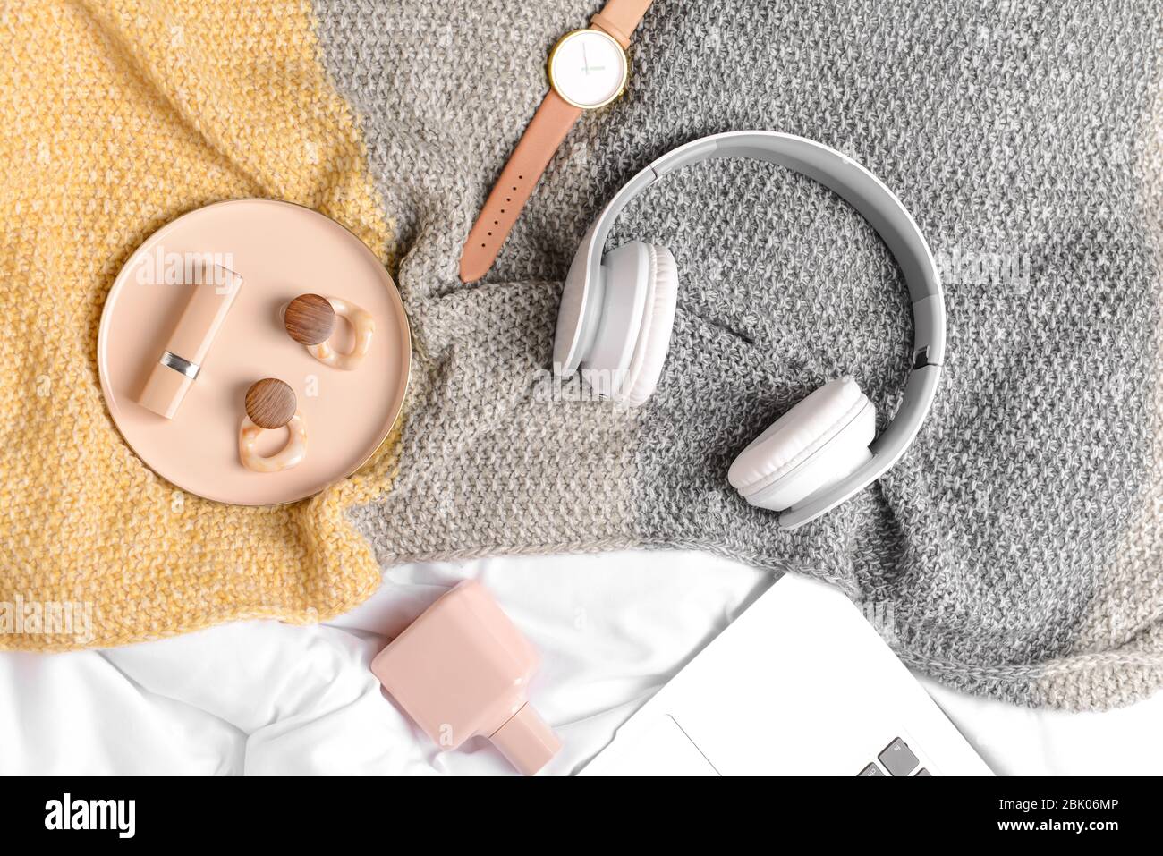 Modern headphones and female accessories on bed Stock Photo - Alamy