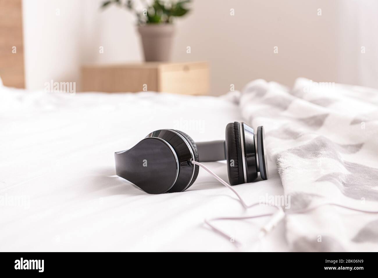 Modern stylish headphones on bed Stock Photo - Alamy