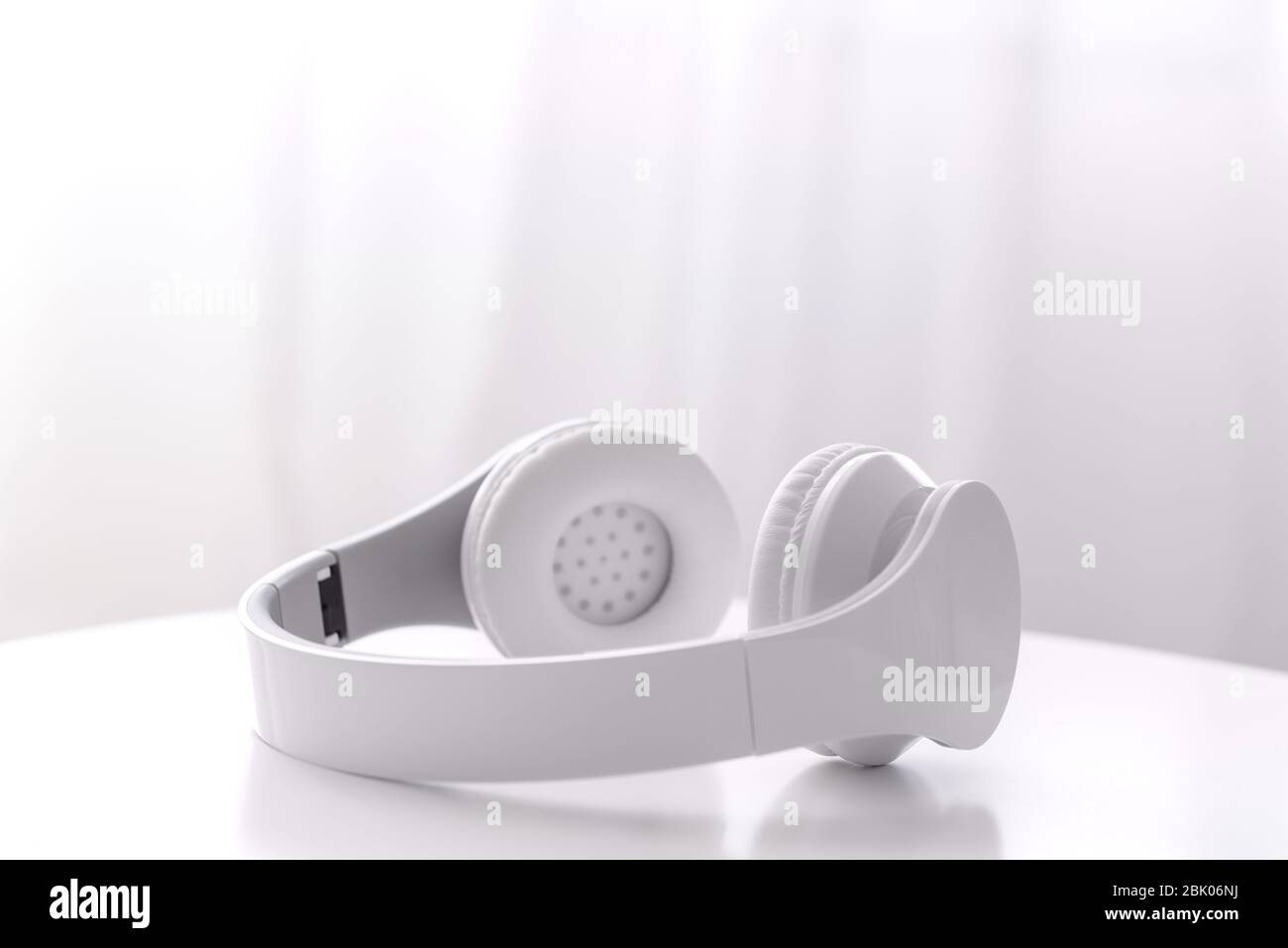 Modern headphones on table in room Stock Photo - Alamy