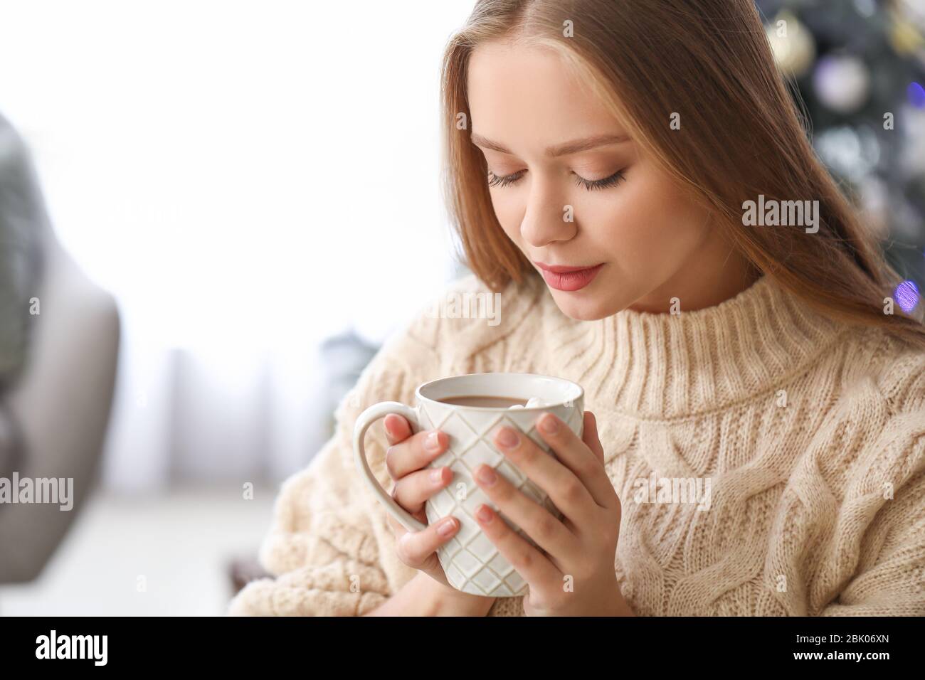 Beautiful woman drinking hot chocolate at home Stock Photo - Alamy