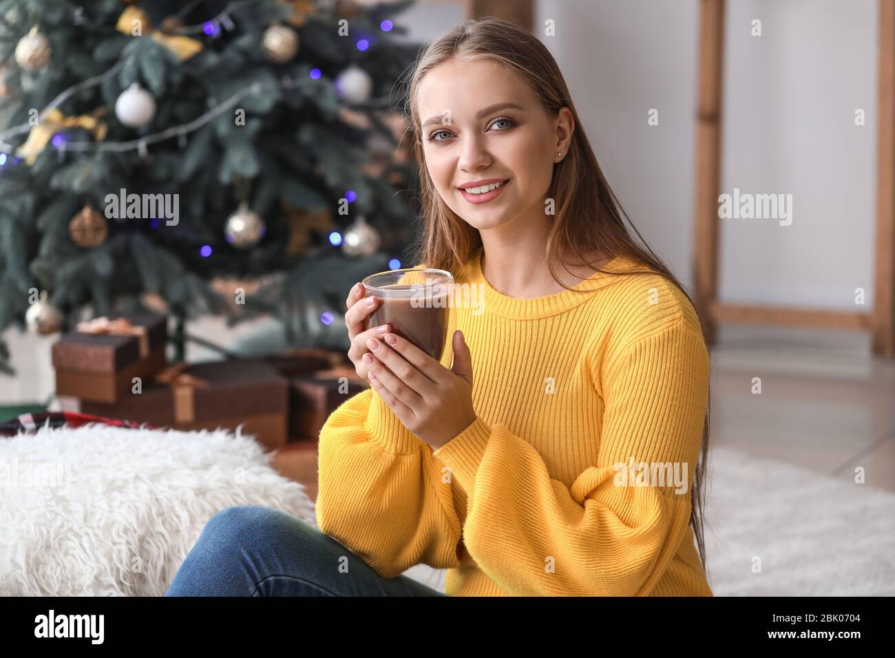 Beautiful woman drinking hot chocolate at home Stock Photo - Alamy