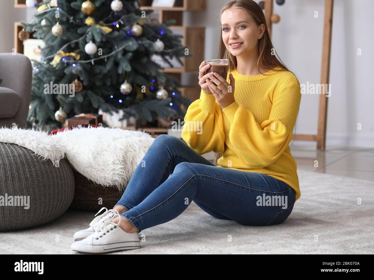 Beautiful woman drinking hot chocolate at home Stock Photo - Alamy