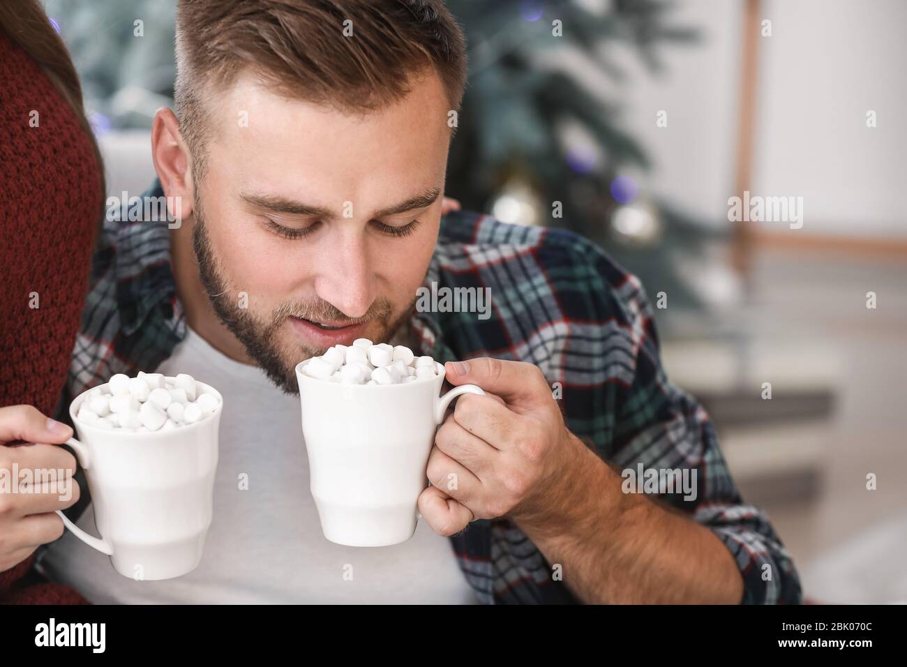 Handsome man drinking hot chocolate at home Stock Photo - Alamy