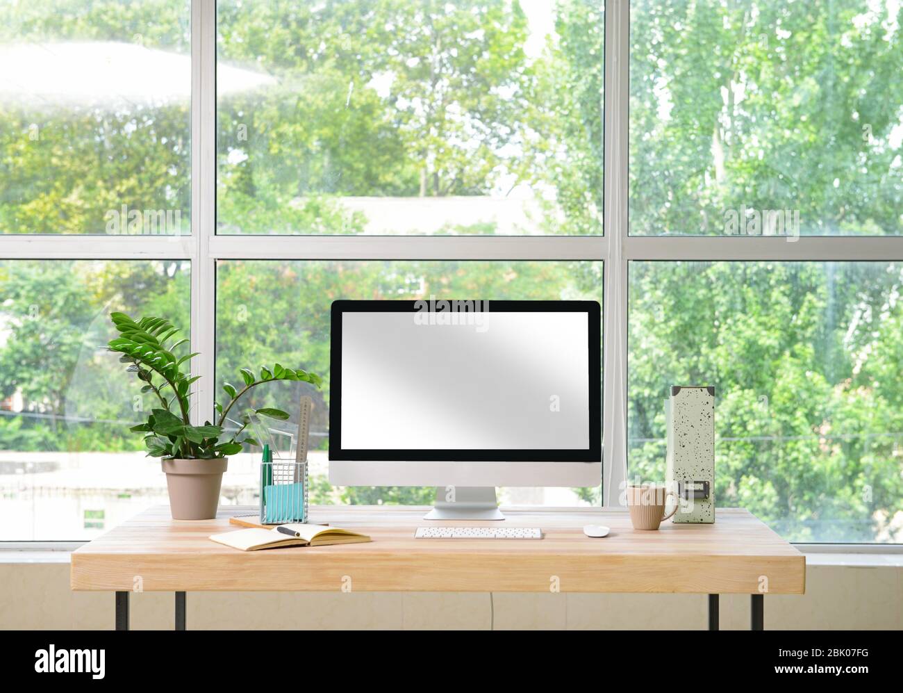 Stylish workplace with modern computer near window Stock Photo - Alamy