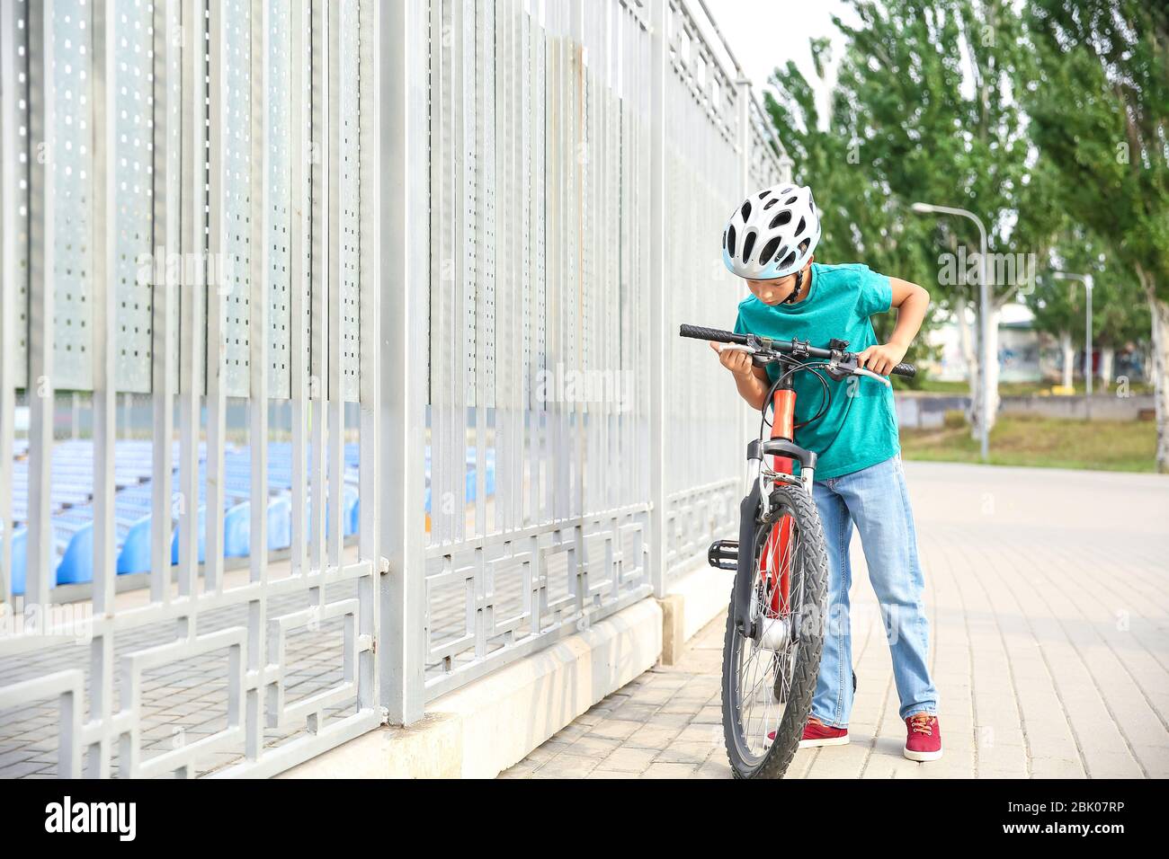 Cute little boy riding bicycle outdoors Stock Photo - Alamy