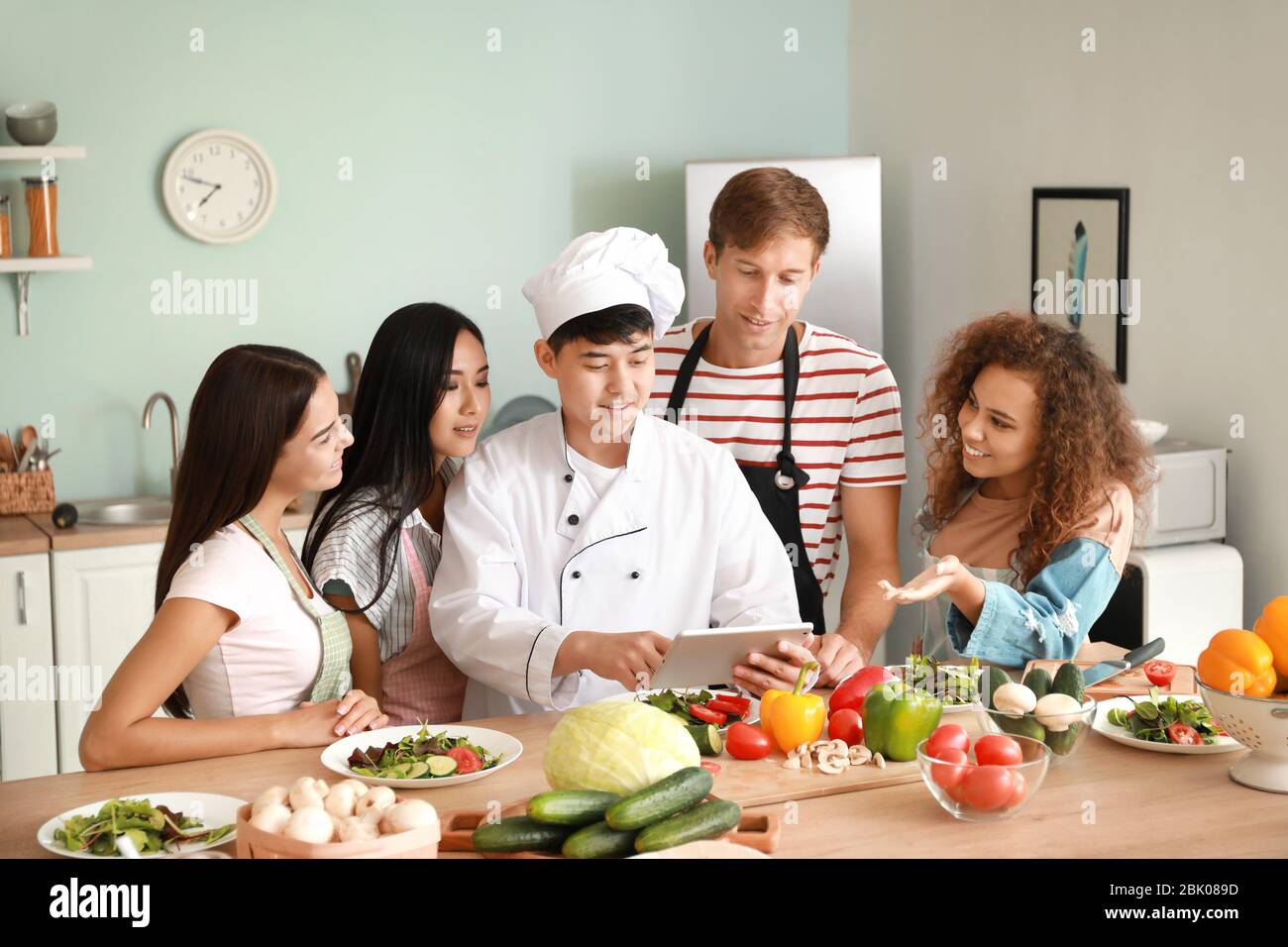 Asian chef and group of young people during cooking classes Stock Photo ...