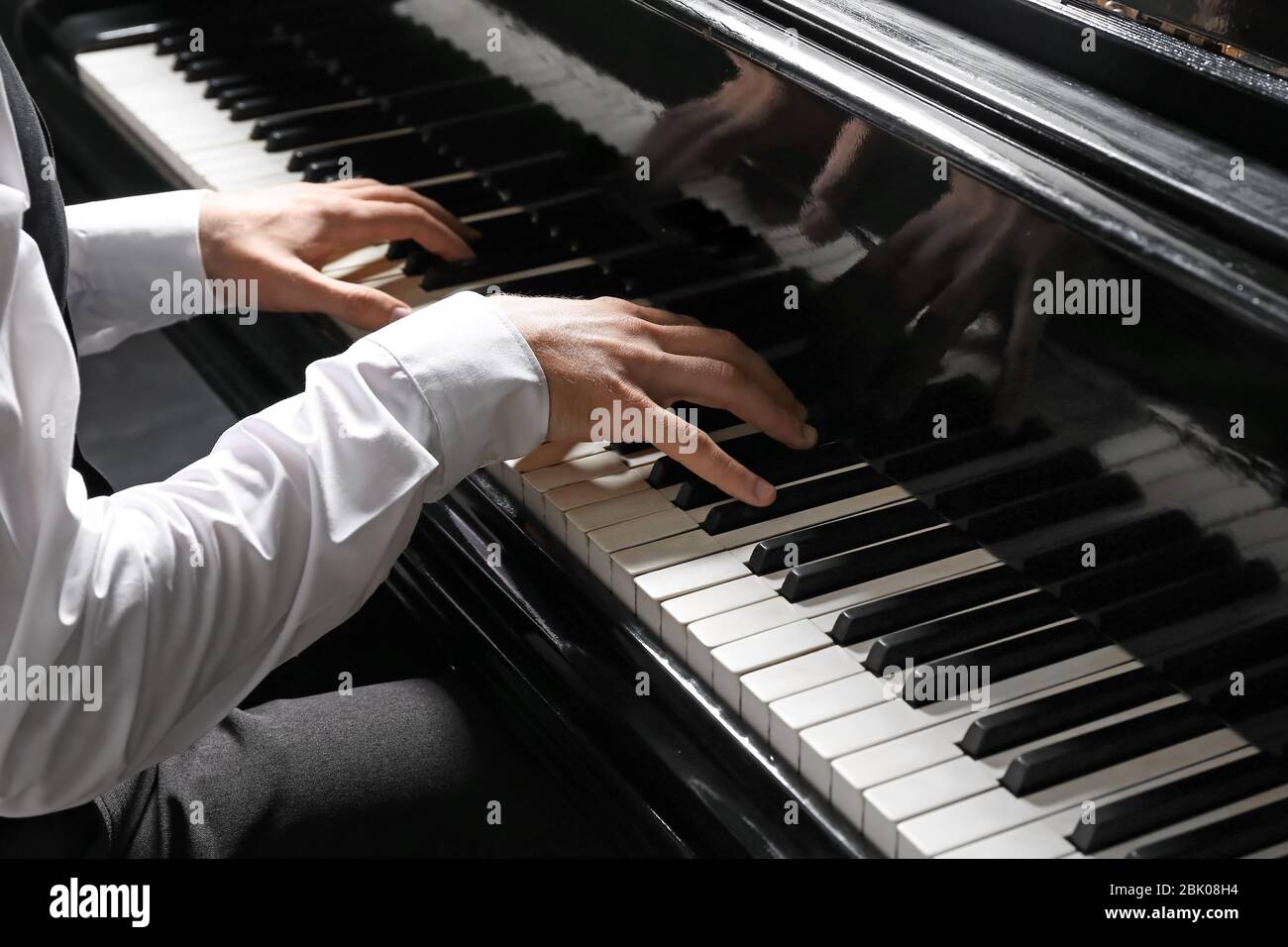 Man playing grand piano at the concert, closeup Stock Photo - Alamy