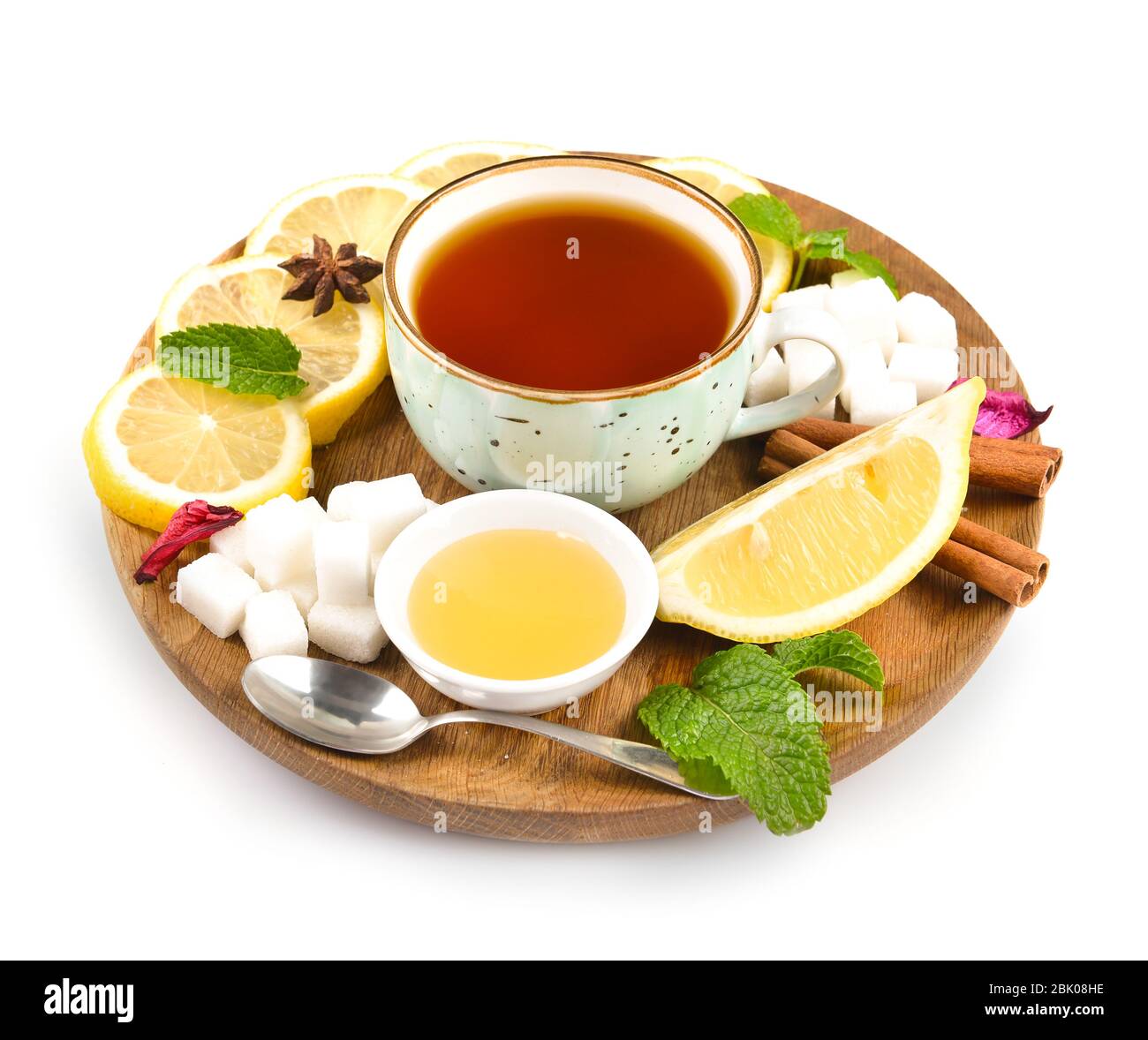 Cup of tasty tea with sugar, lemon, honey and spices on white ...