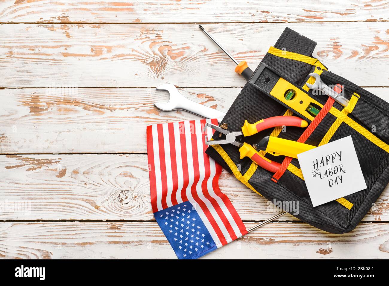 Set of tools, card with text HAPPY LABOR DAY and USA flag on wooden ...