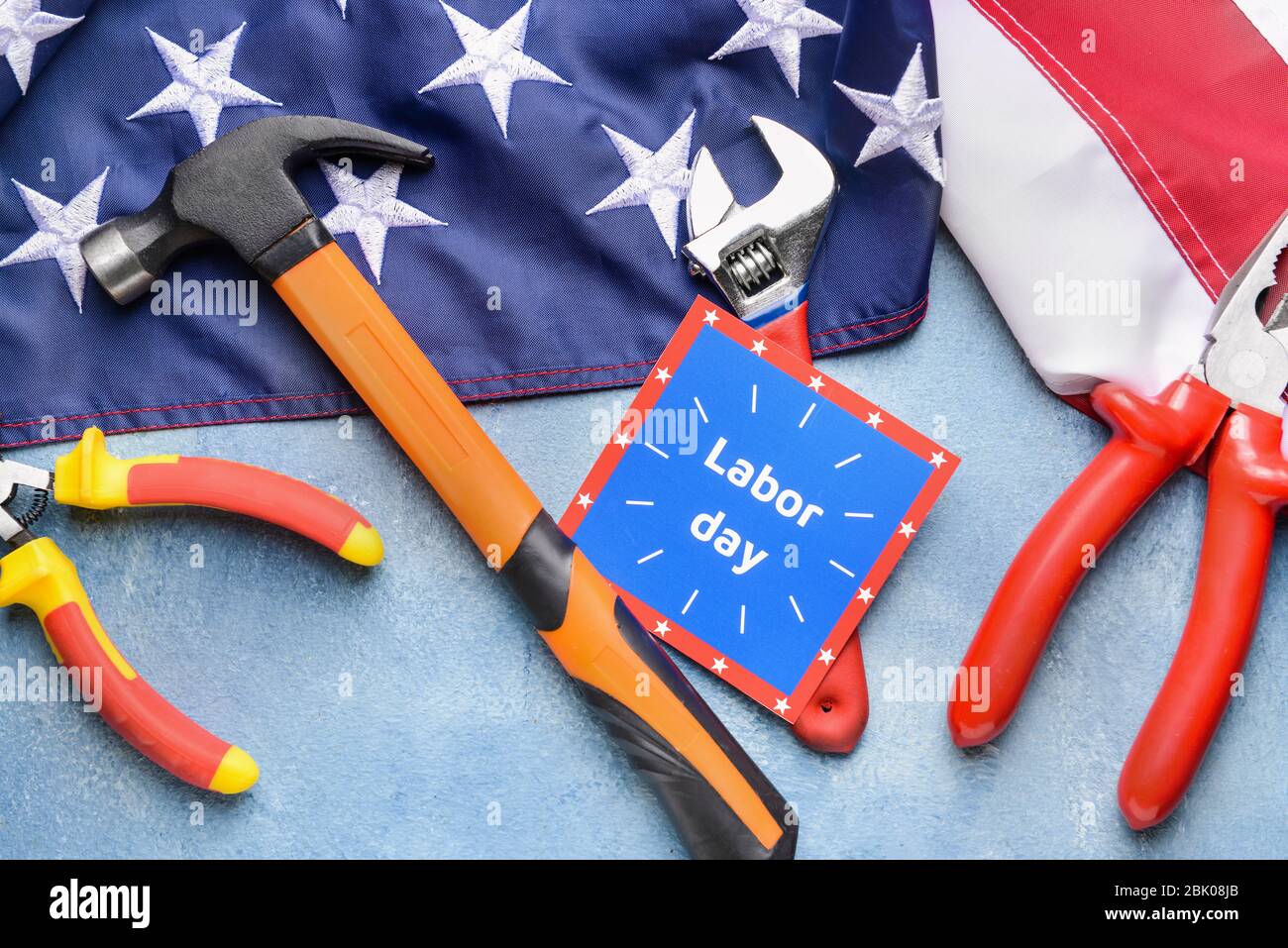 Set of tools, card with text LABOR DAY and USA flag on color background ...