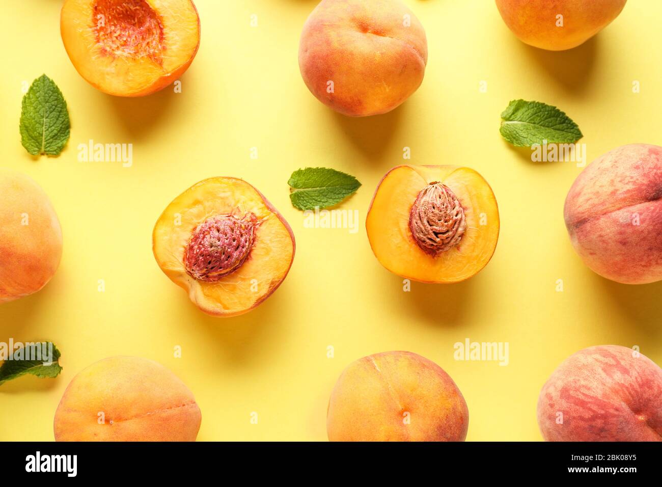 Many ripe peaches on color background Stock Photo - Alamy