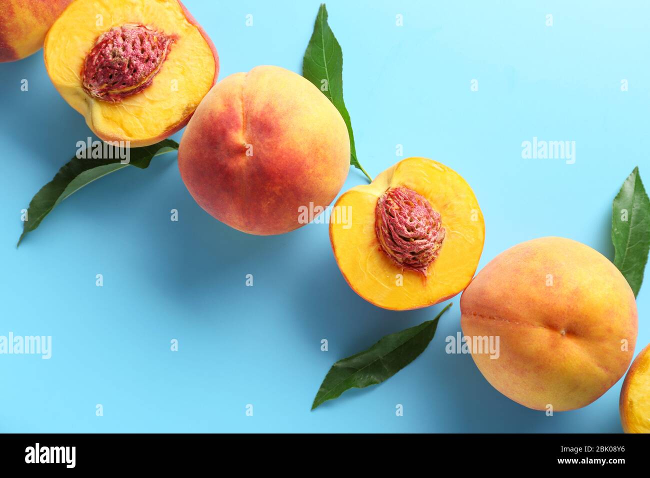 Ripe peaches on color background Stock Photo - Alamy
