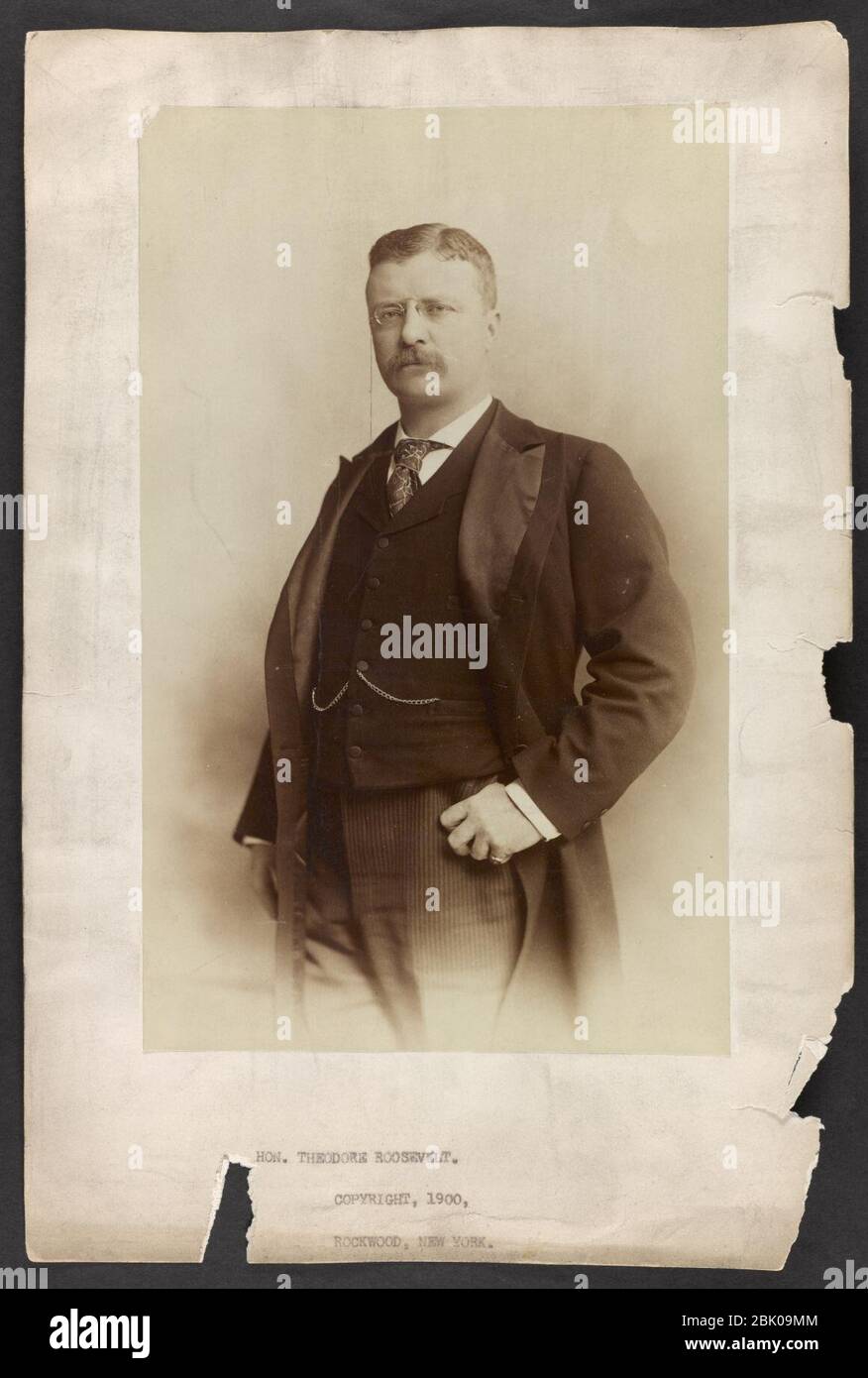 Hon. Theodore Roosevelt, three-quarter length portrait, standing, thumb ...