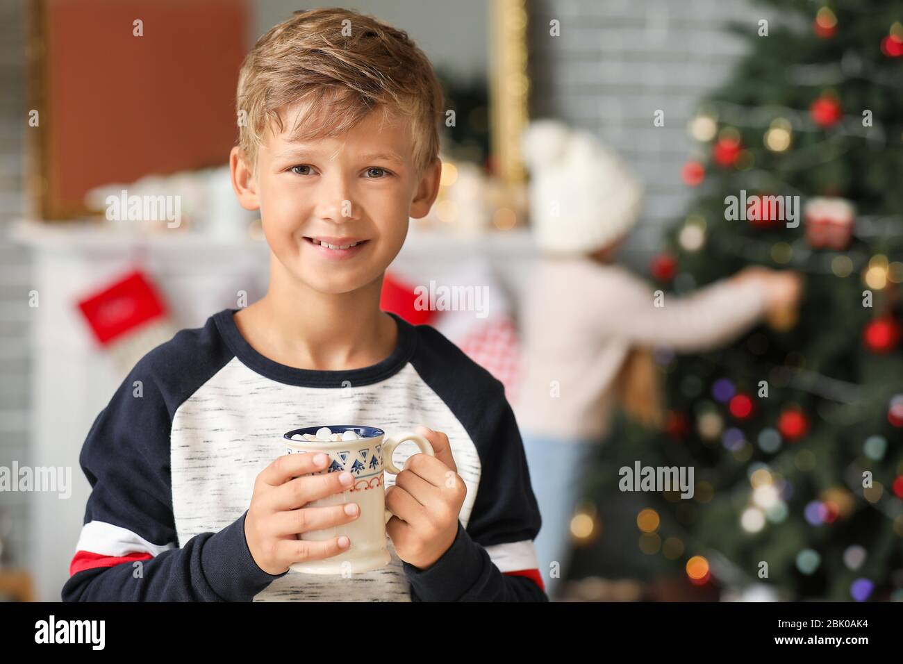 Cute little boy drinking hot chocolate at home on Christmas eve Stock ...