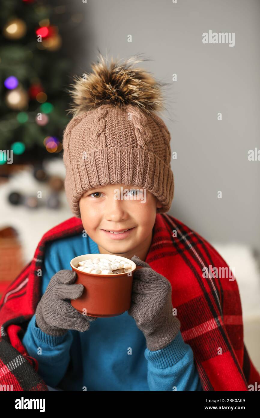 Cute little boy drinking hot chocolate at home on Christmas eve Stock ...