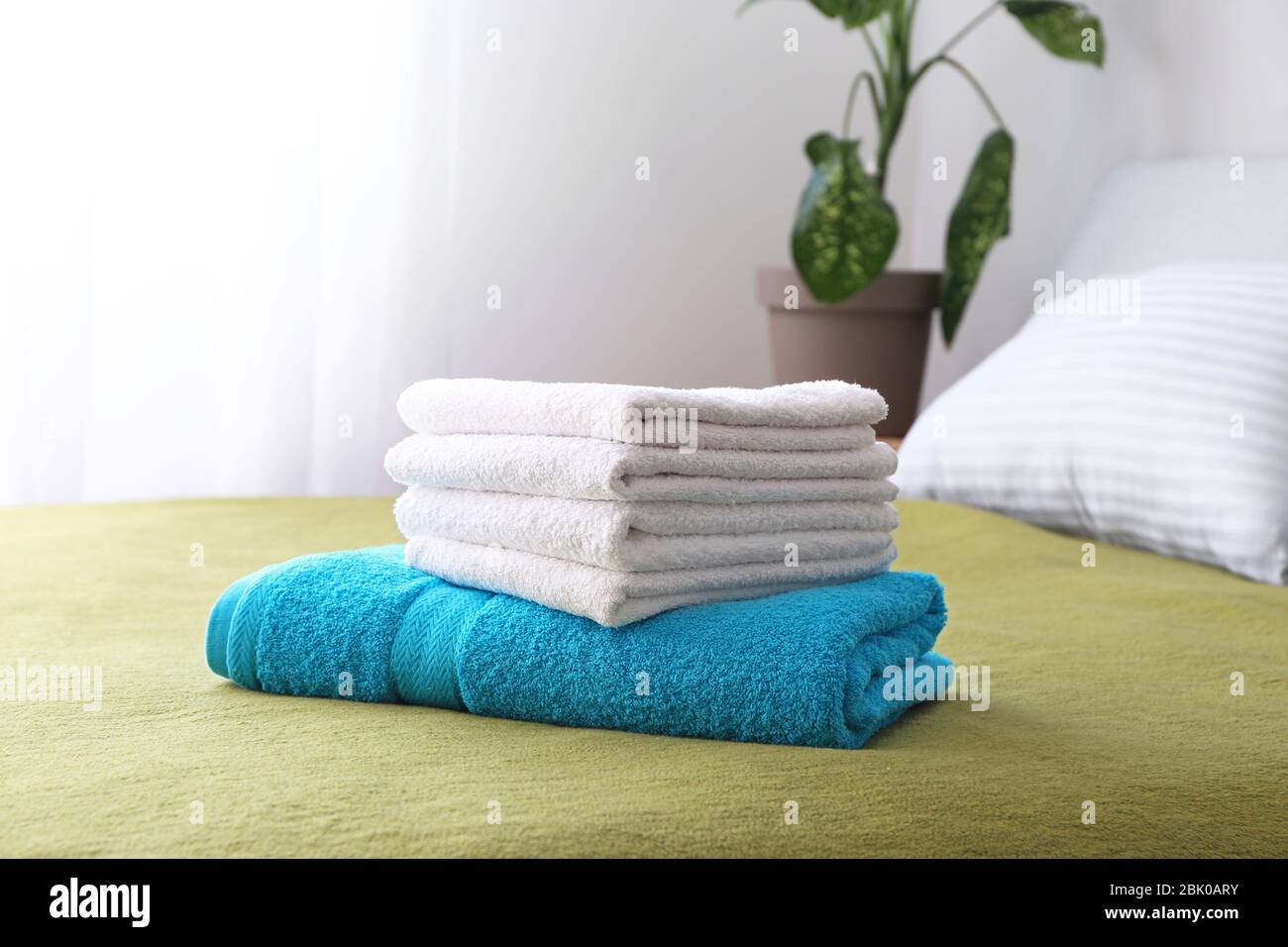 Clean soft towels on bed Stock Photo - Alamy