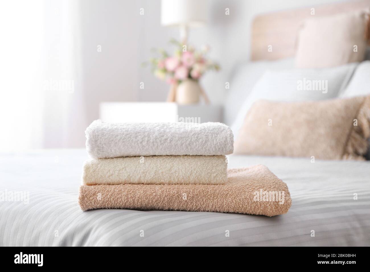 Stack of clean towels on bed Stock Photo - Alamy