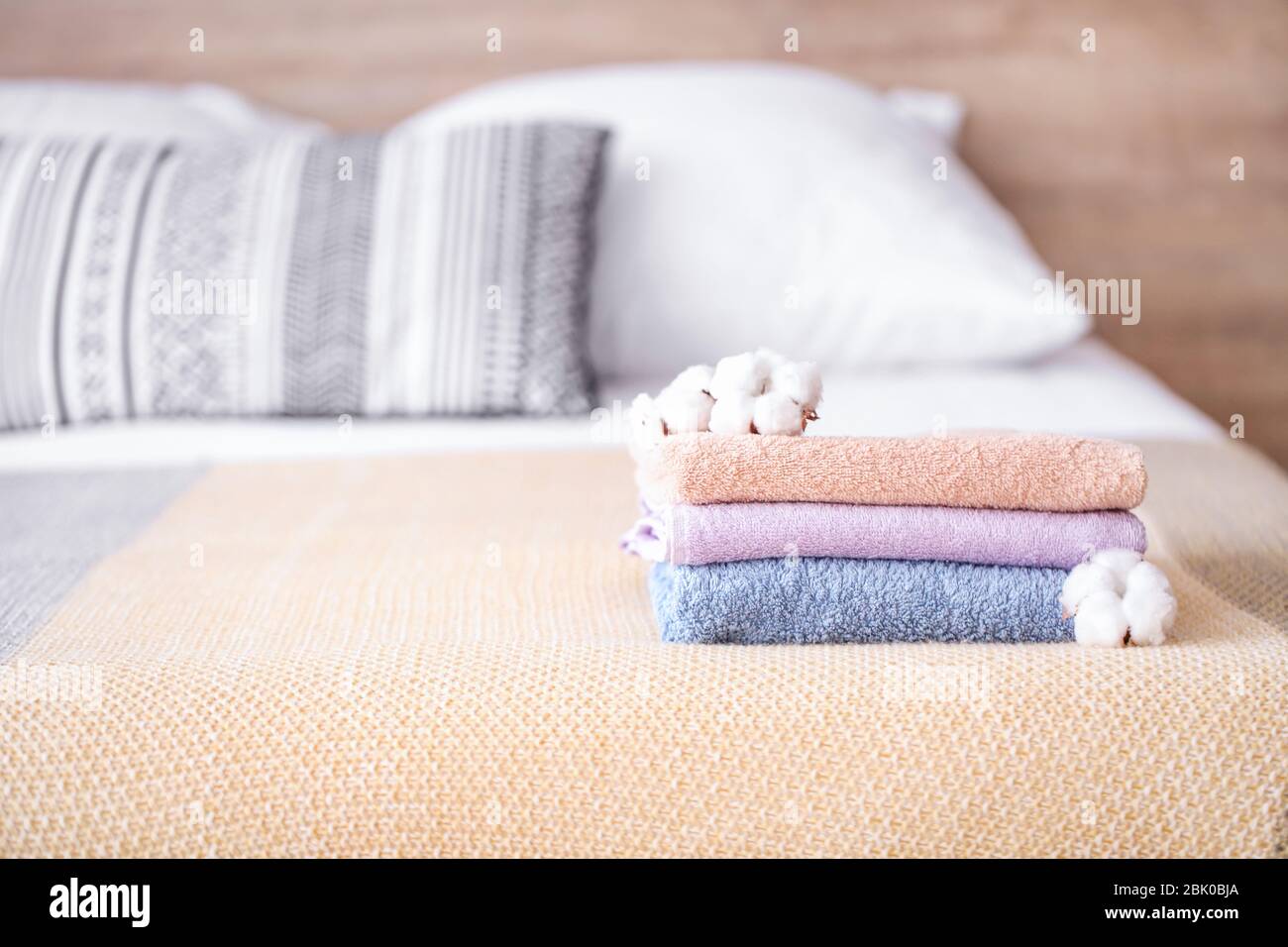 Stack of clean towels on bed Stock Photo - Alamy