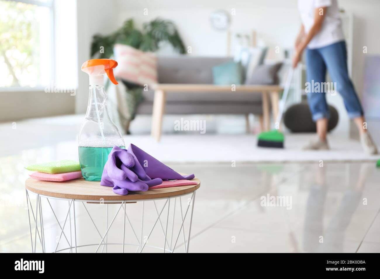 Set of cleaning supplies on table in room Stock Photo - Alamy