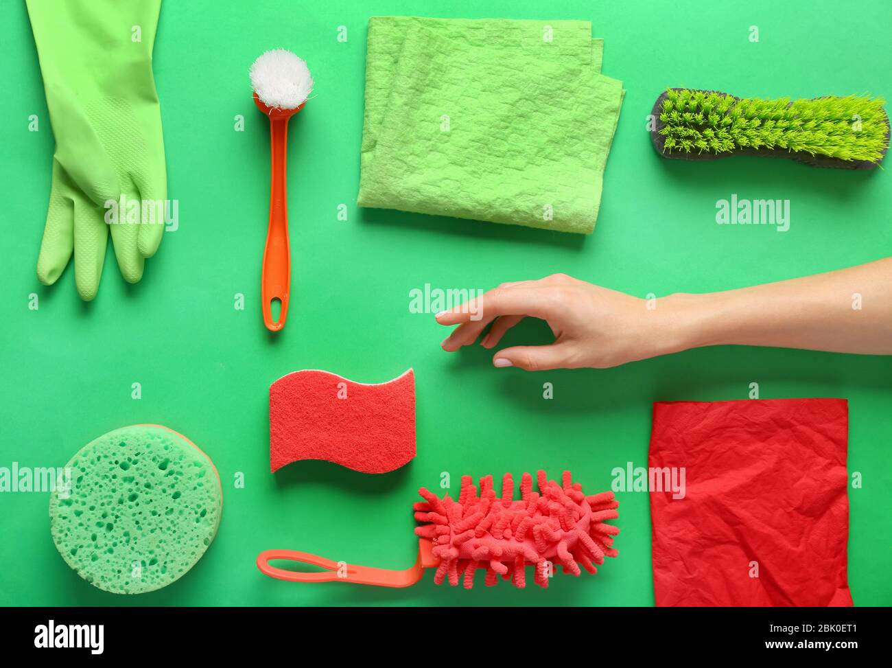 Female hand with cleaning supplies on color background Stock Photo - Alamy
