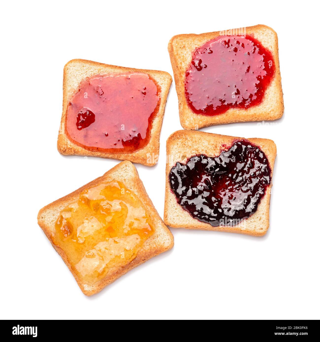 Tasty toasted bread with different jams on white background Stock Photo ...