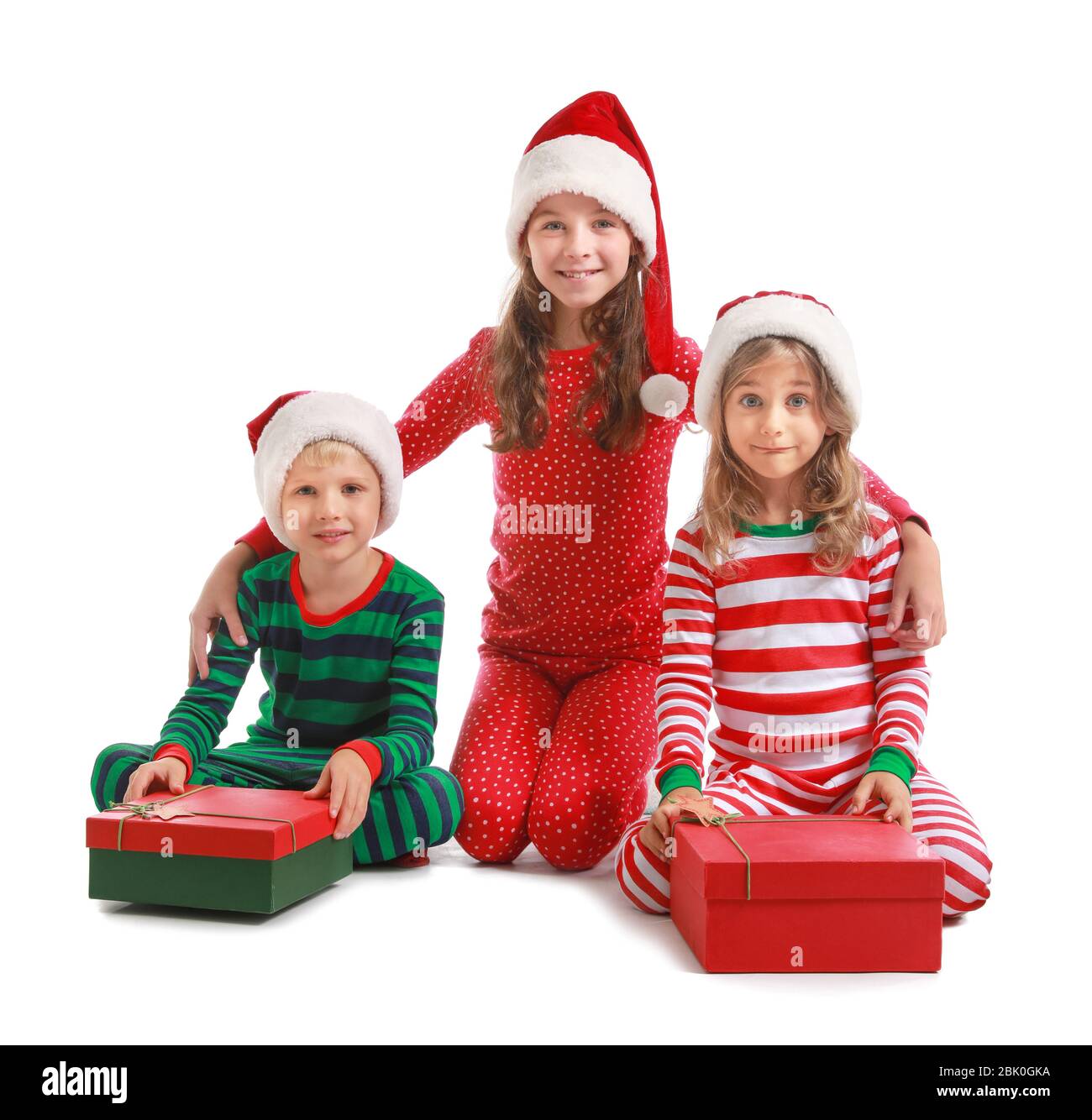 Cute little children with Christmas gifts on white background Stock ...